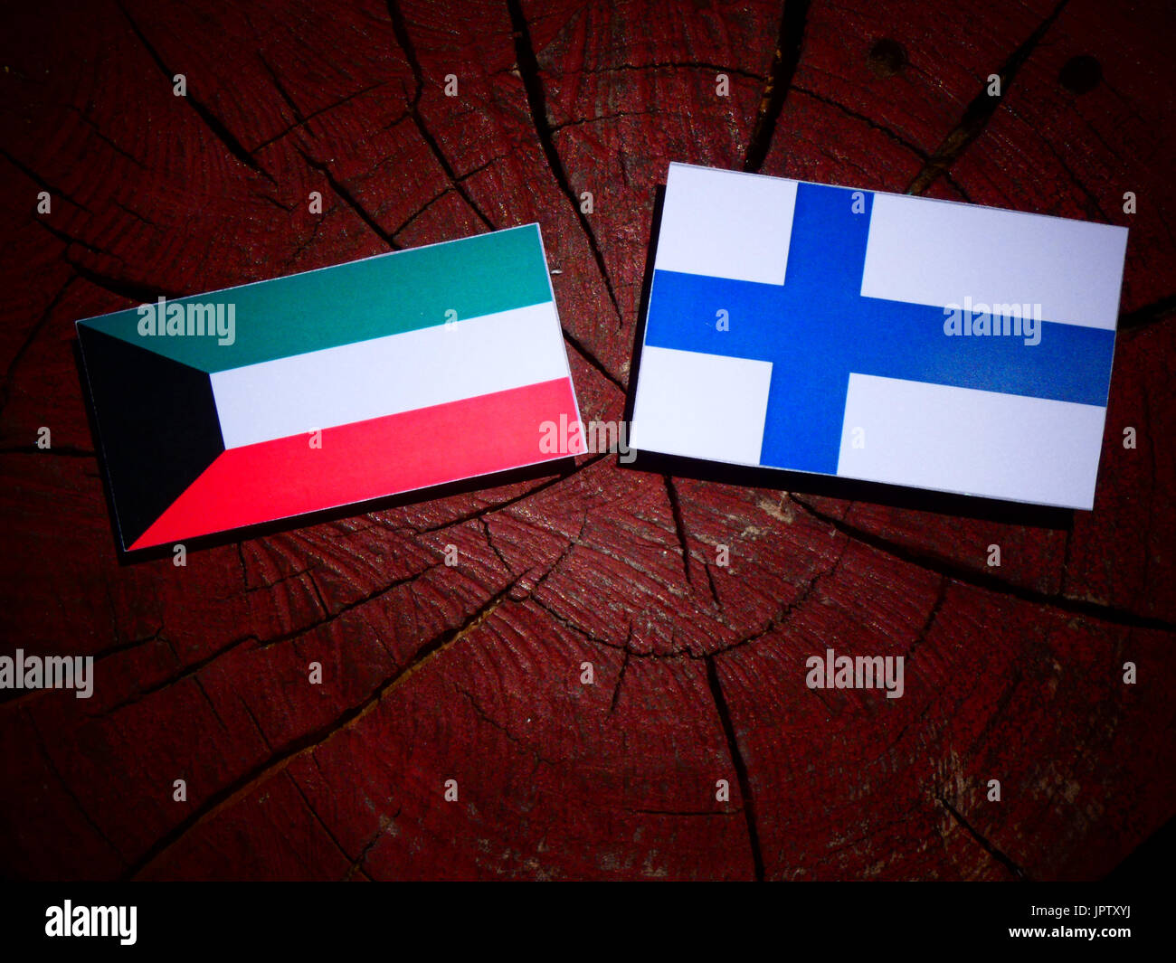 Kuwaiti flag with Finnish flag on a tree stump isolated Stock Photo - Alamy