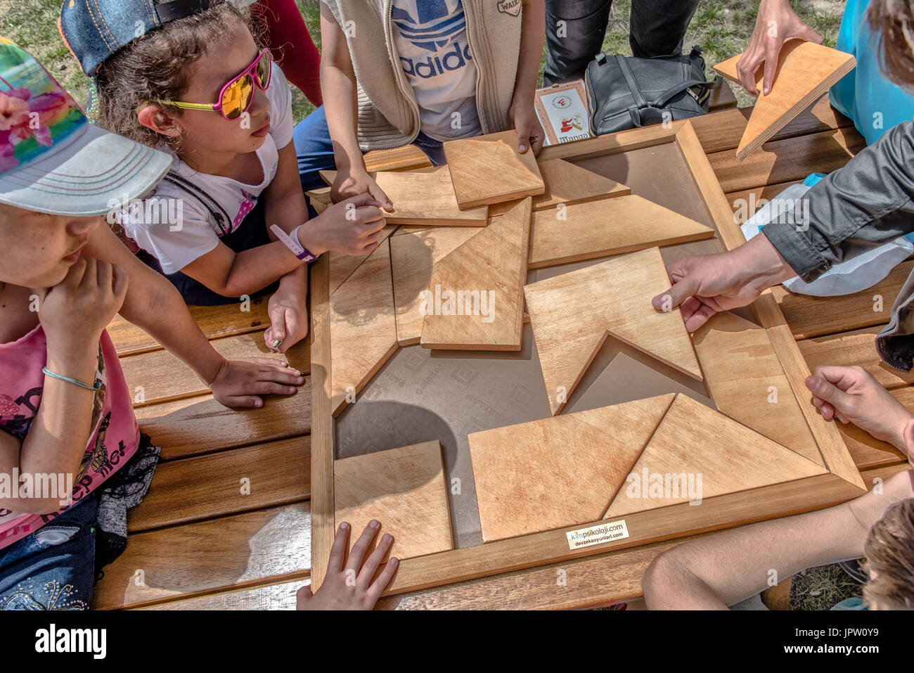 Unidentified children play a traditional Turkish wooden puzzle game ...