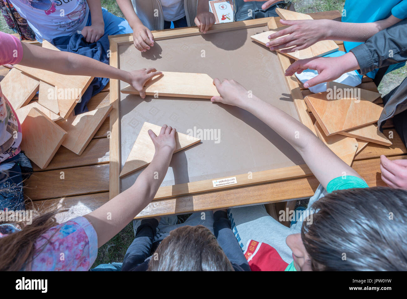 Unidentified children play a traditional Turkish wooden puzzle game ...