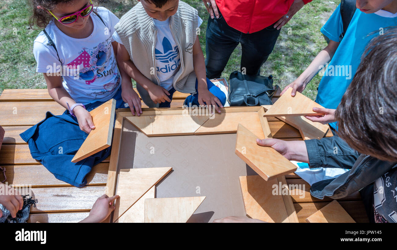 Unidentified children play a traditional Turkish wooden puzzle game ...