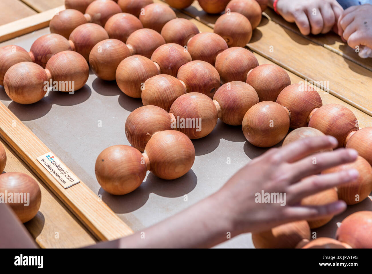 Unidentified children play a traditional Turkish wooden puzzle game ...