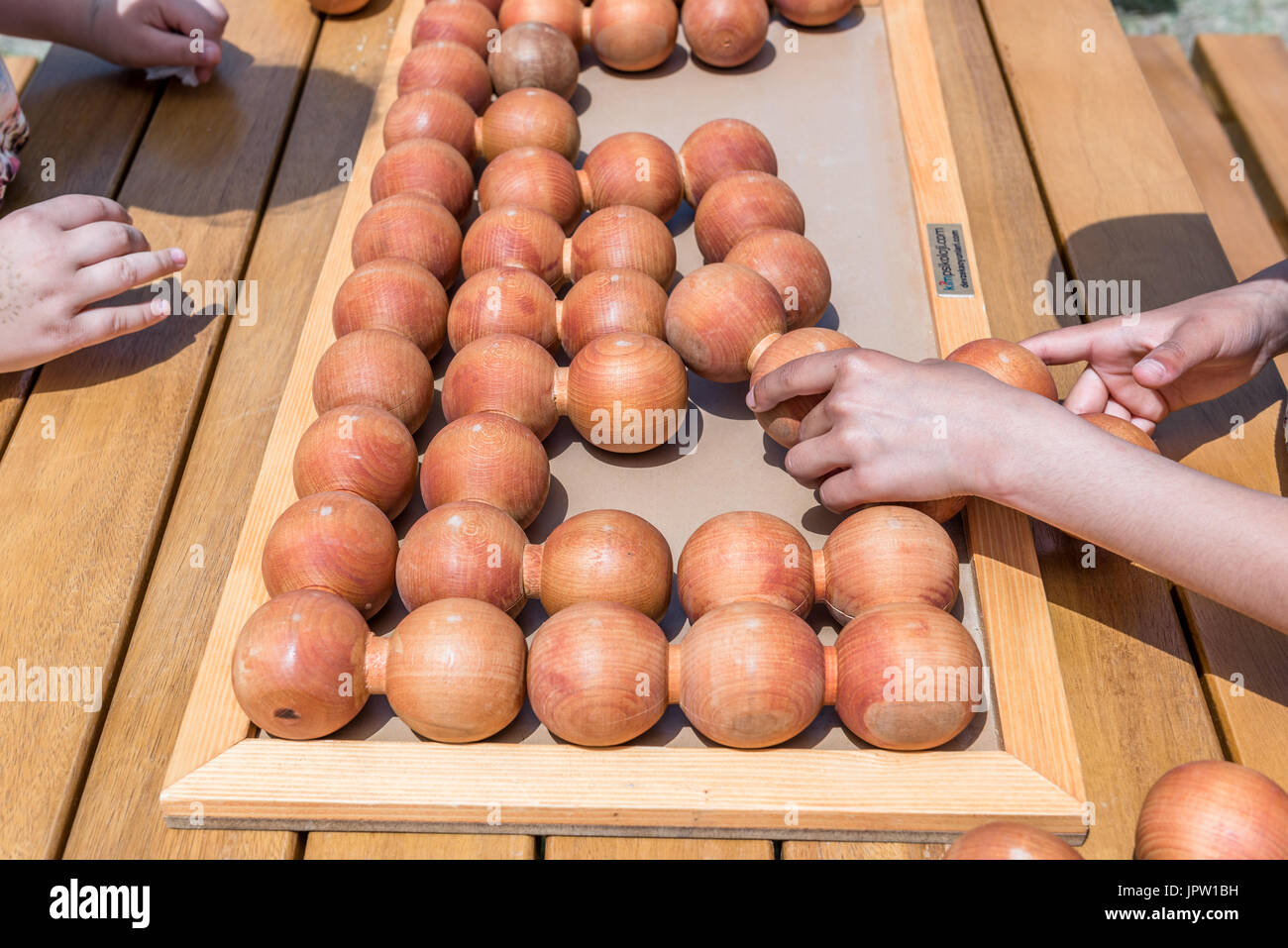 Unidentified children play a traditional Turkish wooden puzzle game ...