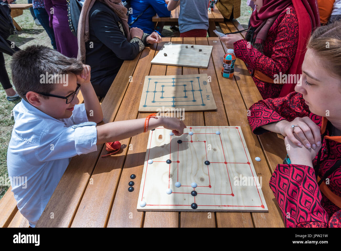 Unidentified children play a traditional Turkish wooden puzzle game ...