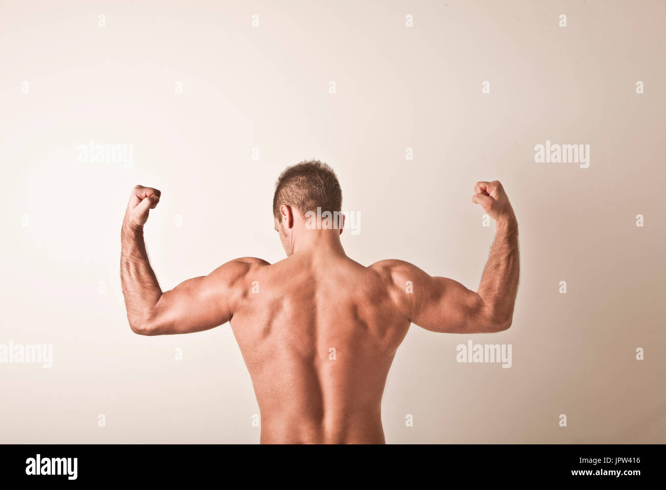 man showing the muscles Stock Photo - Alamy