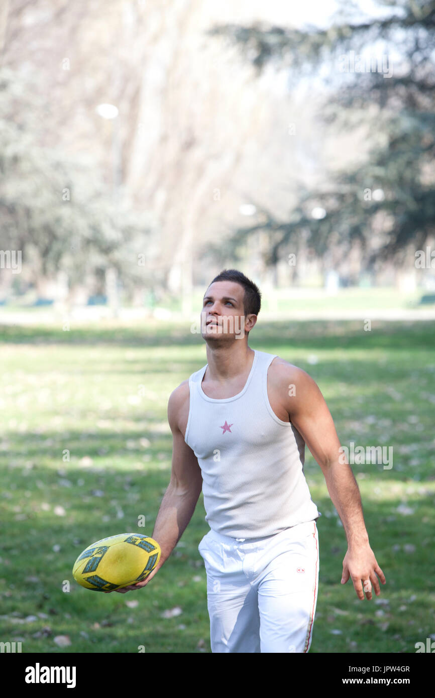 man playing football in the park Stock Photo - Alamy
