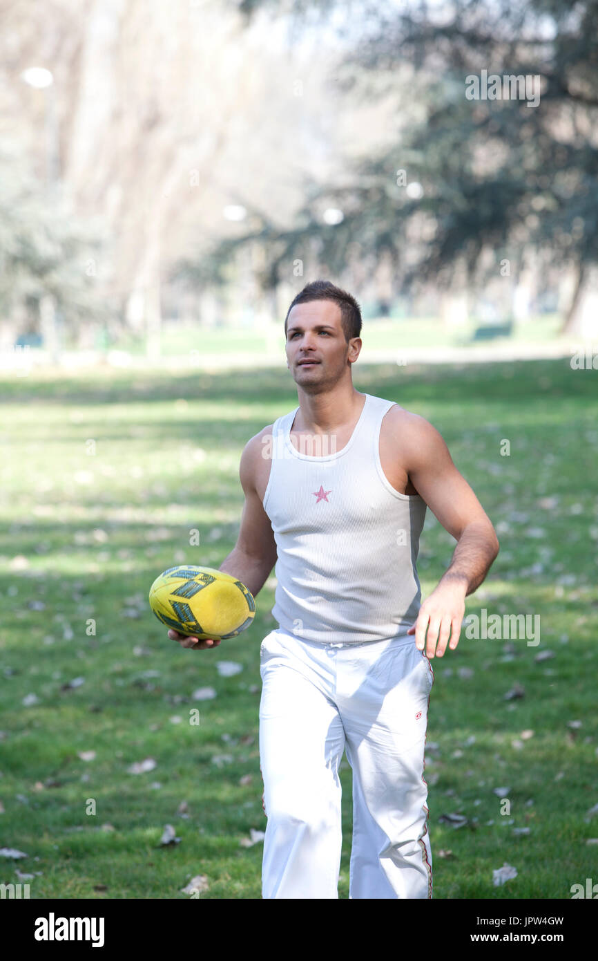 man playing football in the park Stock Photo - Alamy