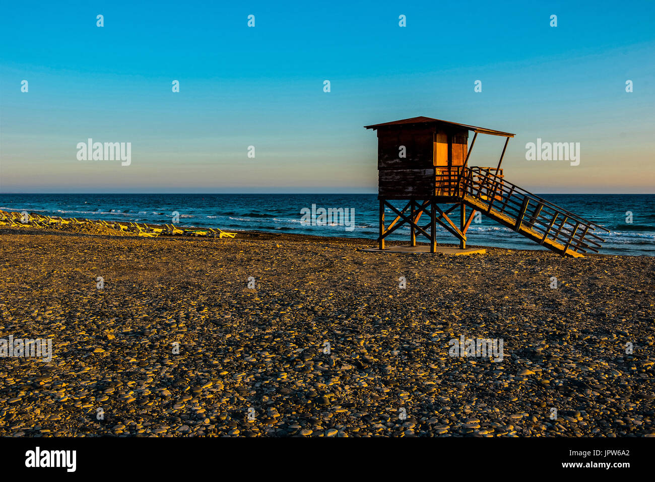 Baywatch tower on the beach. Lifeguard tower in the sunset. Toned and ...