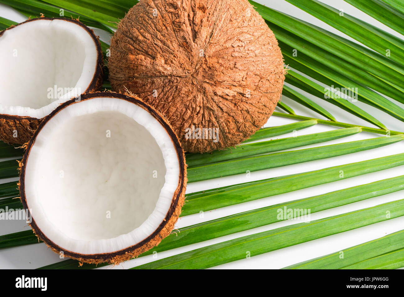 Coconut with half and leaves on white background Stock Photo - Alamy