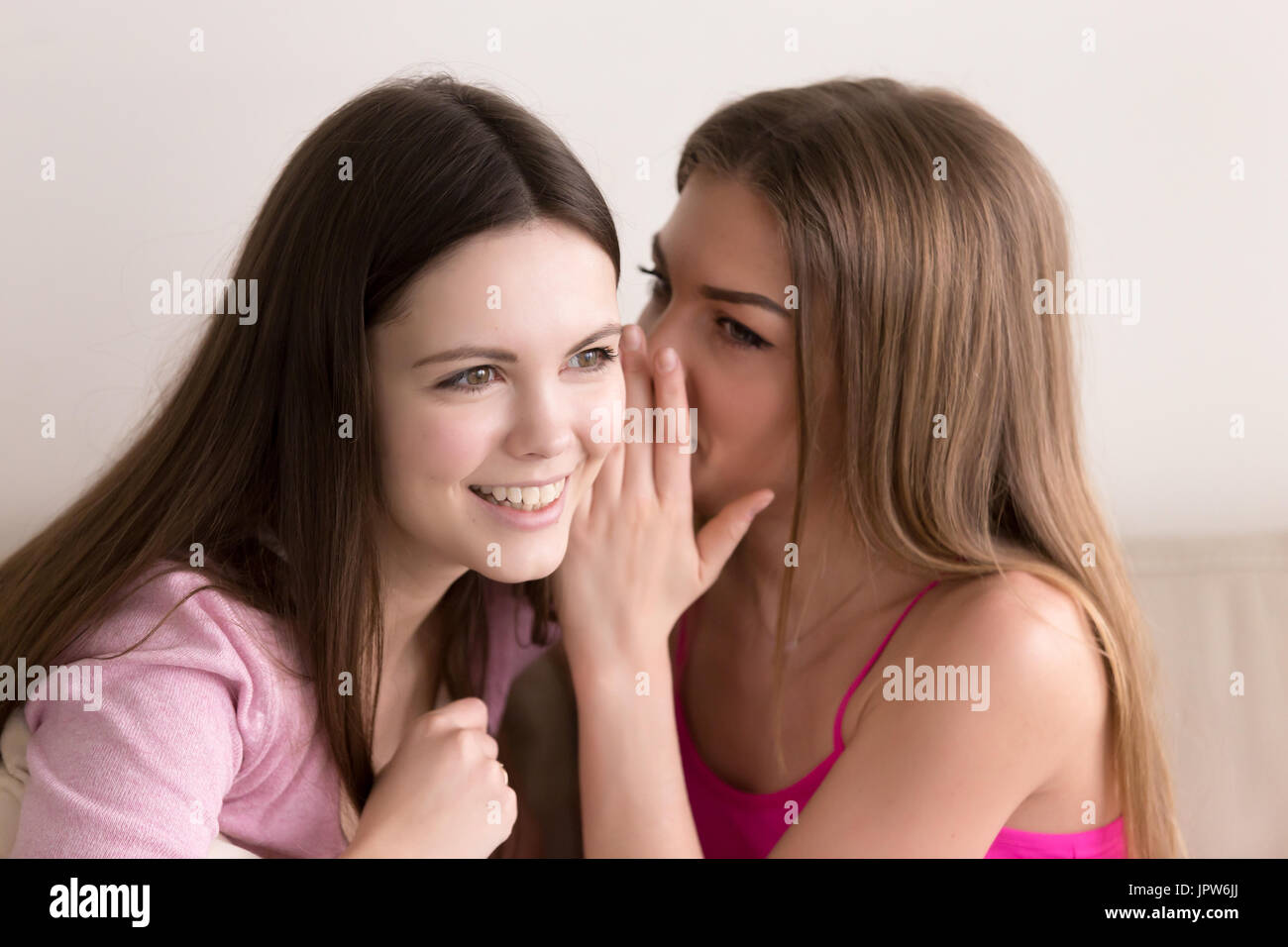 Whispering in ear hi-res stock photography and images - Alamy