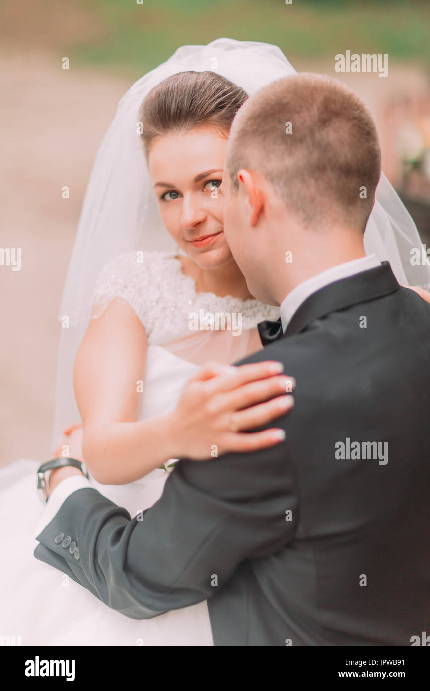 The close-up portrait of the pretty bride hugging with the groom Stock ...