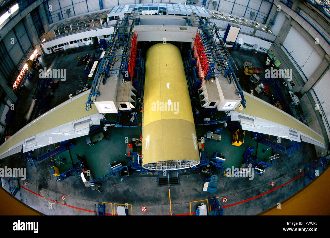 wings being joined to the Airbus A330 fuselage on the production-line ...