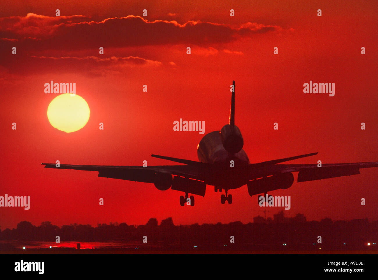 McDonnell Douglas DC-10-30 landing at sunset over runway lights Stock ...