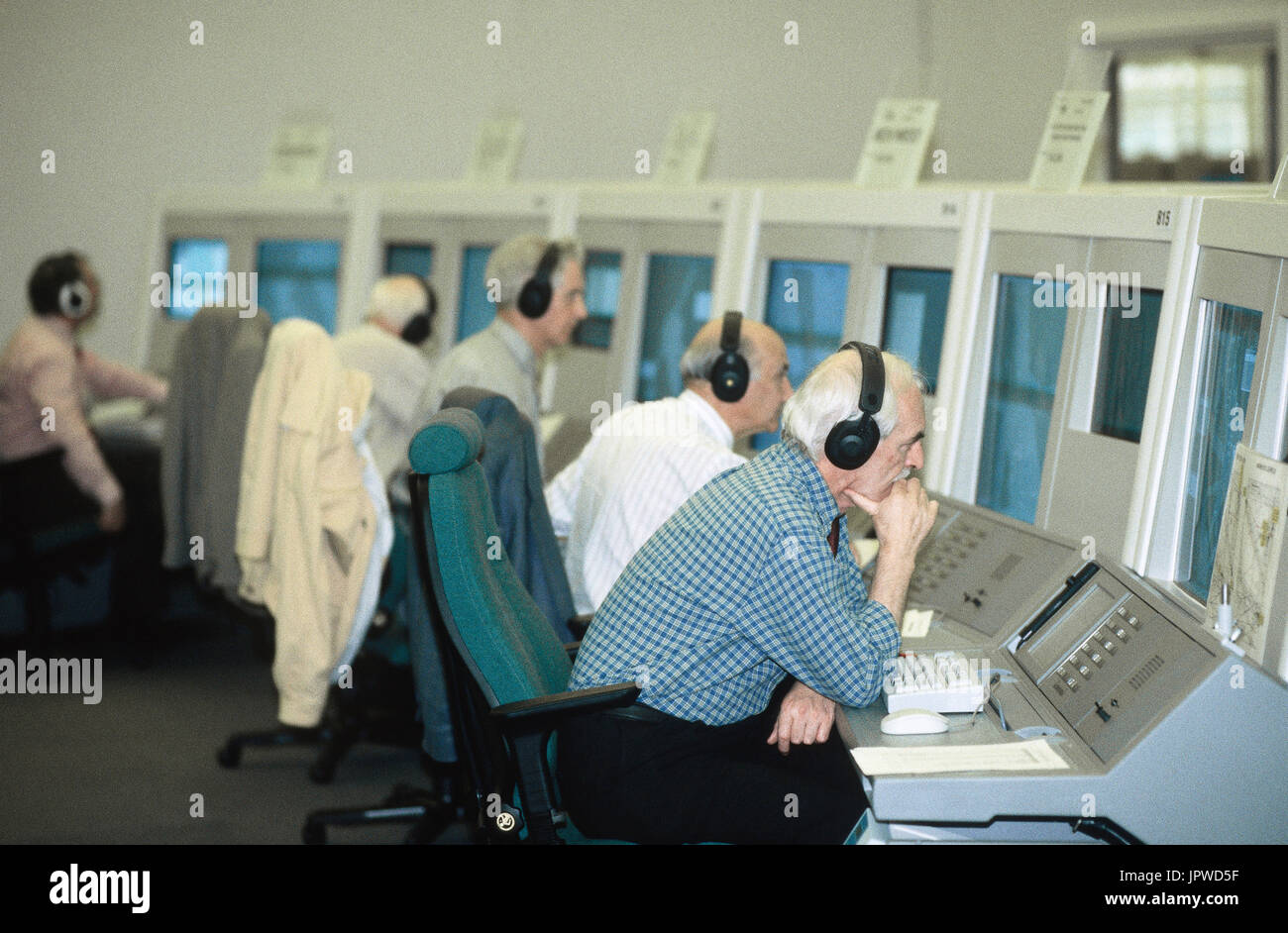 ATC-controllers with headphones and computer keyboards at the NATS ...