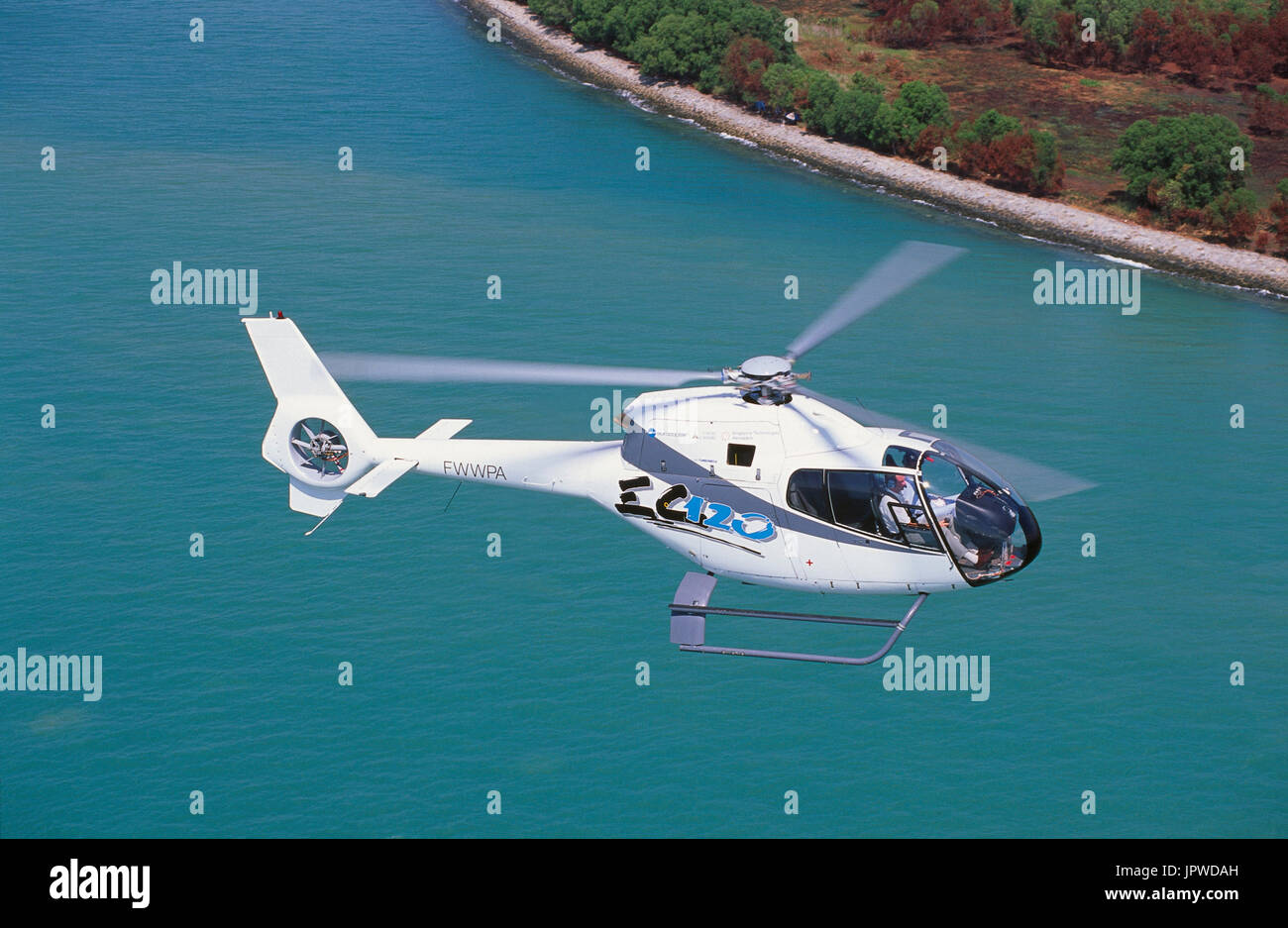 Eurocopter EC-120 Colibri prototype flying enroute over the turquoise ...