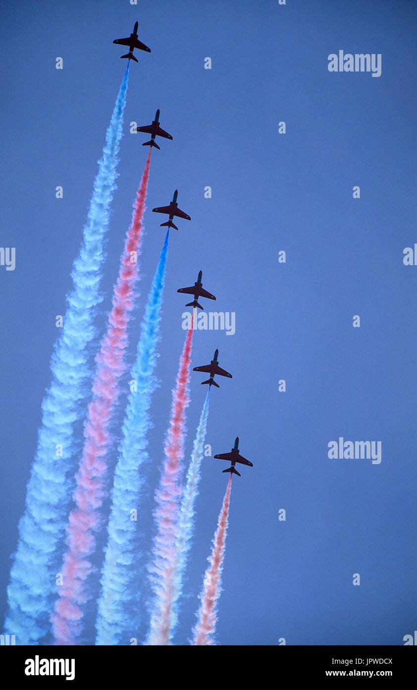 Royal AirForce RAF Red Arrows BAE Hawks with red and blue smoke in the ...