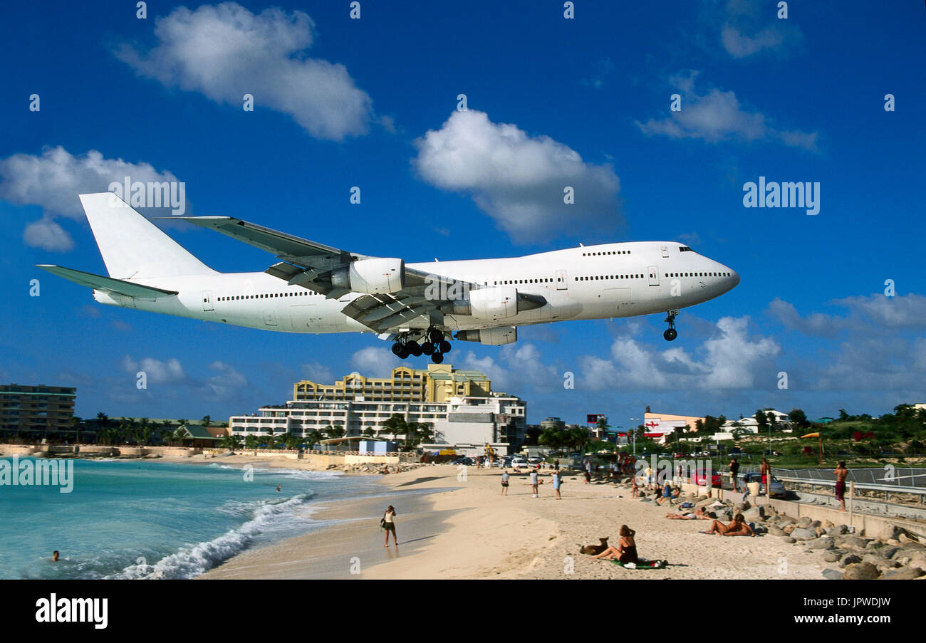 a Boeing 747 airliner on very low final-approach over a beach with ...
