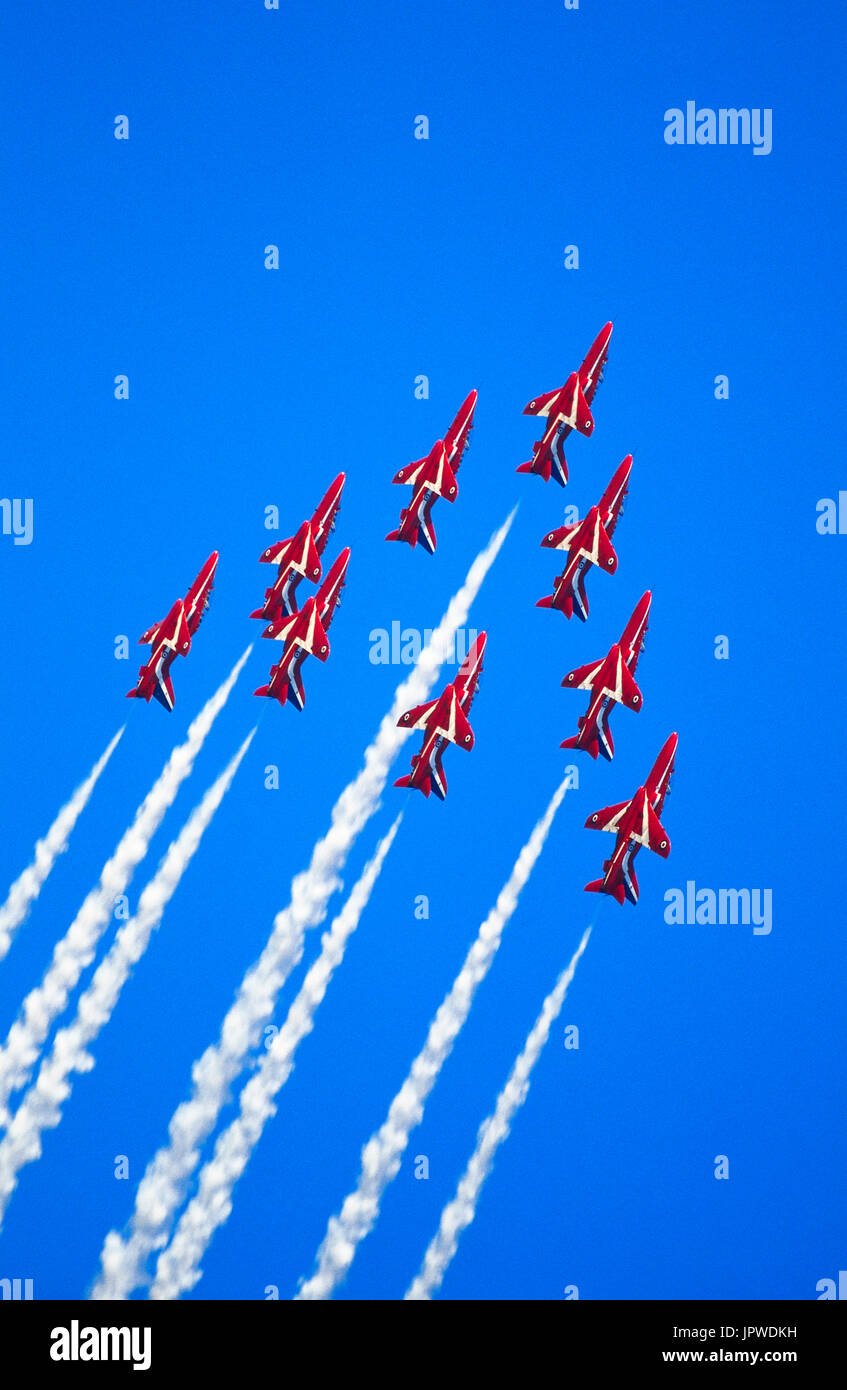 RAF Red Arrows BAE Hawks flying in formation with white smoke in the ...