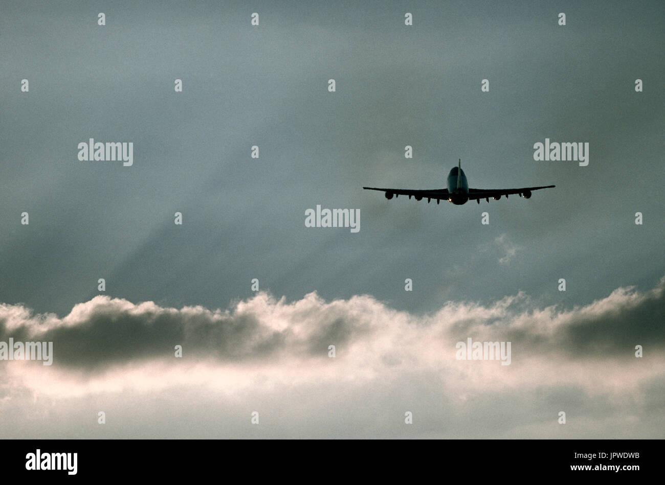 Boeing 747 flying enroute over a layer of clouds Stock Photo - Alamy