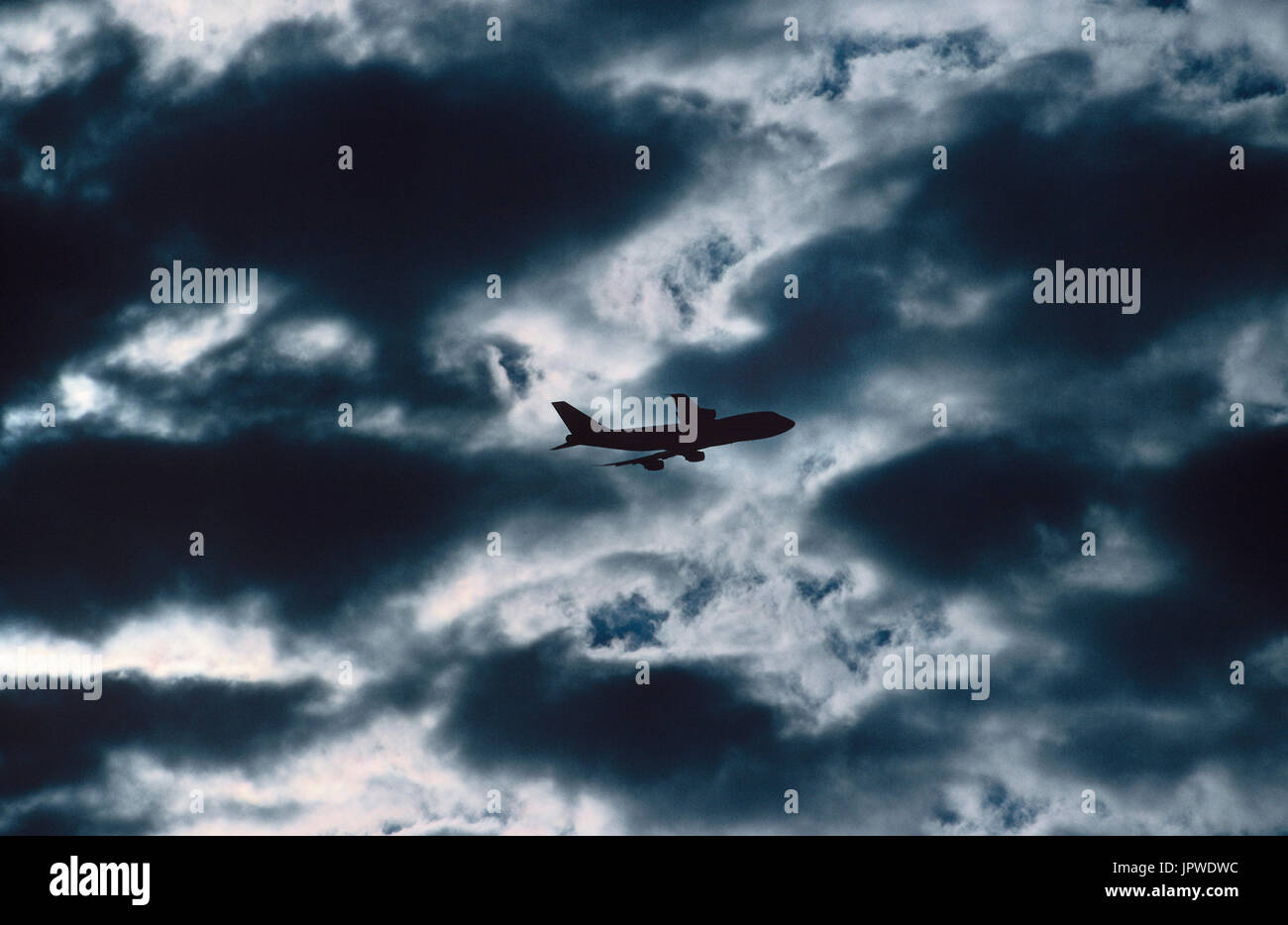 Boeing 747 flying enroute at night with moonlit clouds Stock Photo - Alamy