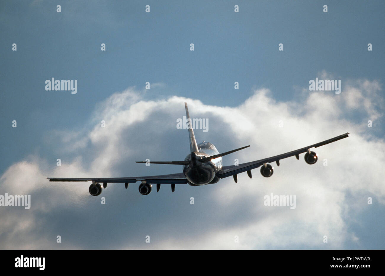 Boeing 747-100 flying enroute with layer of clouds behind Stock Photo ...