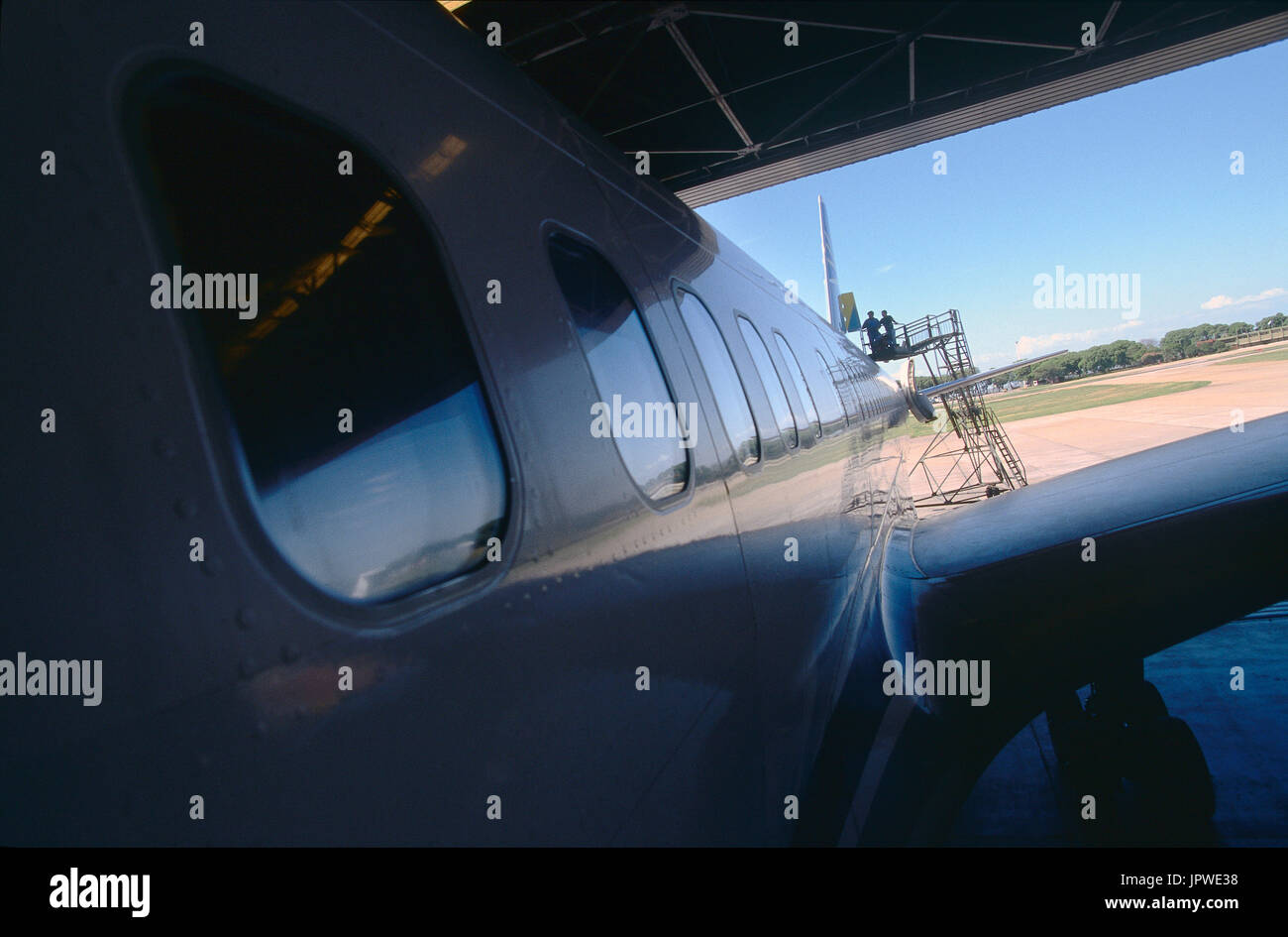 maintenance in a hangar with engineers inspecting the tail of a LAPA ...