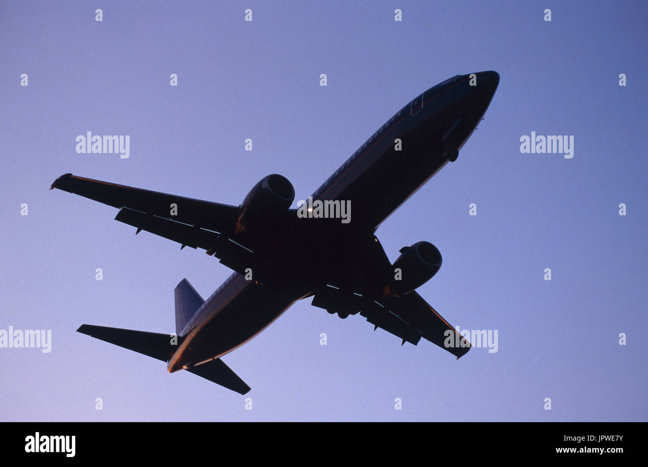generic Boeing 737-300 on final-approach with flaps deployed at dusk ...