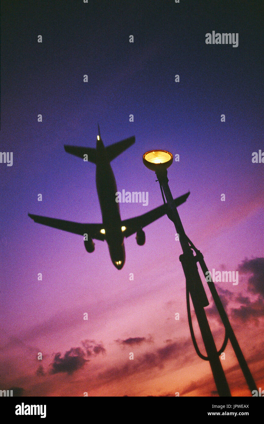 Airbus A320 on final-approach over runway approach-lights at dusk ...