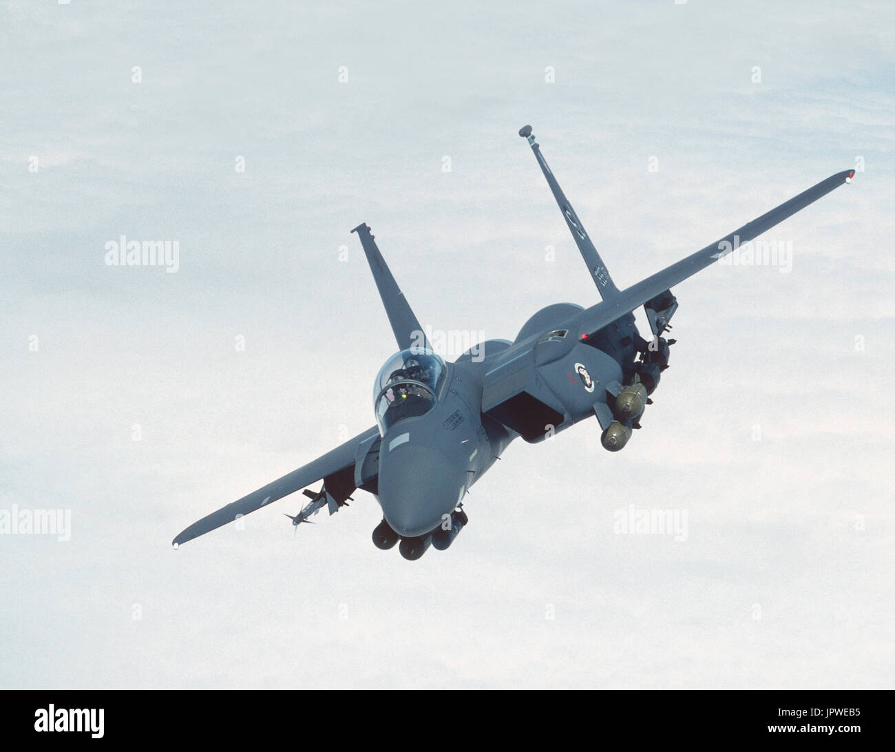 USAF Boeing F-15E Strike Eagle flying enroute above a layer of clouds ...