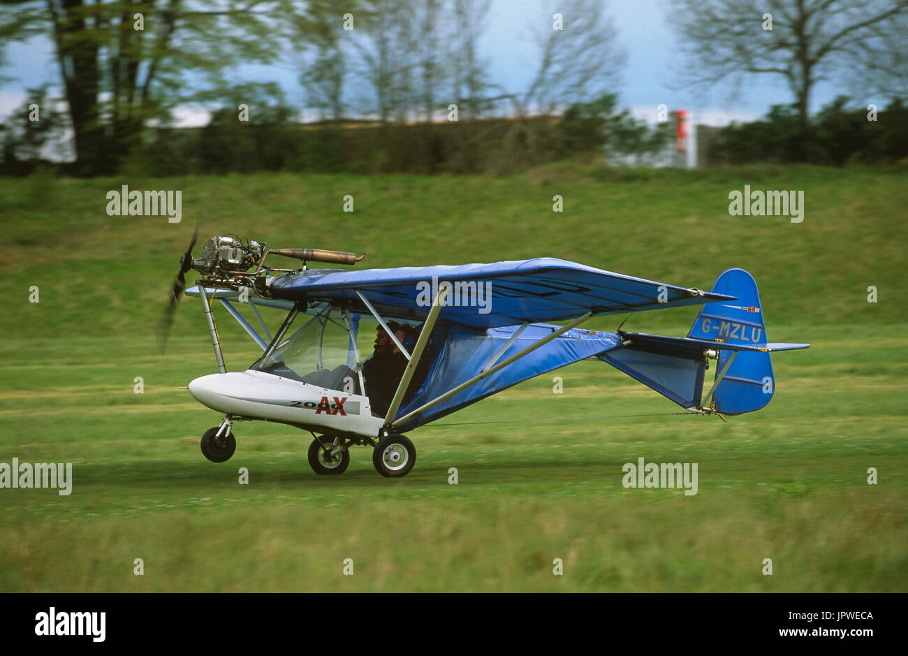 Cyclone AX3-503 microlight taking-off from grass Stock Photo - Alamy