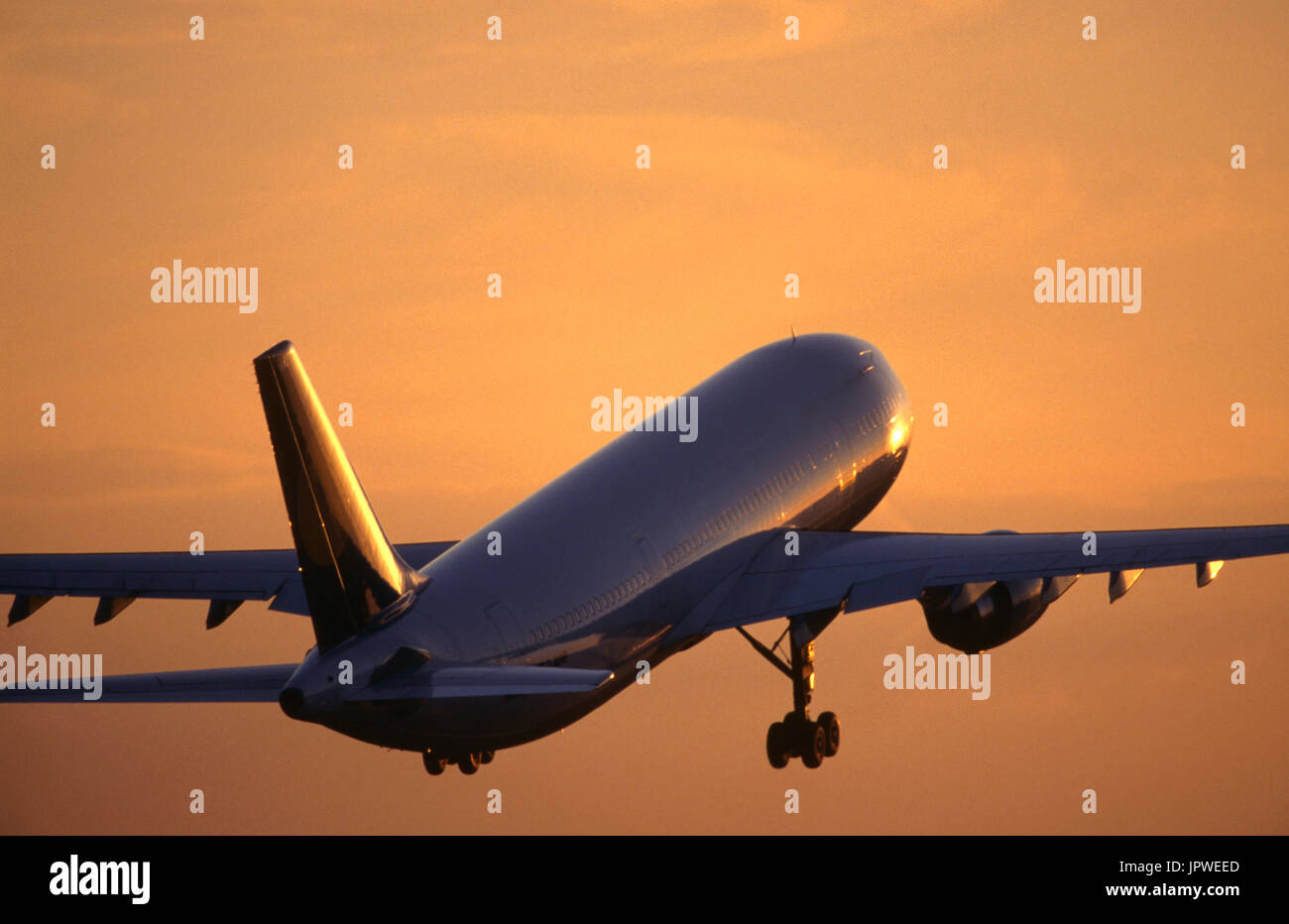 Airbus A300-600 climbing after take-off at dusk Stock Photo - Alamy