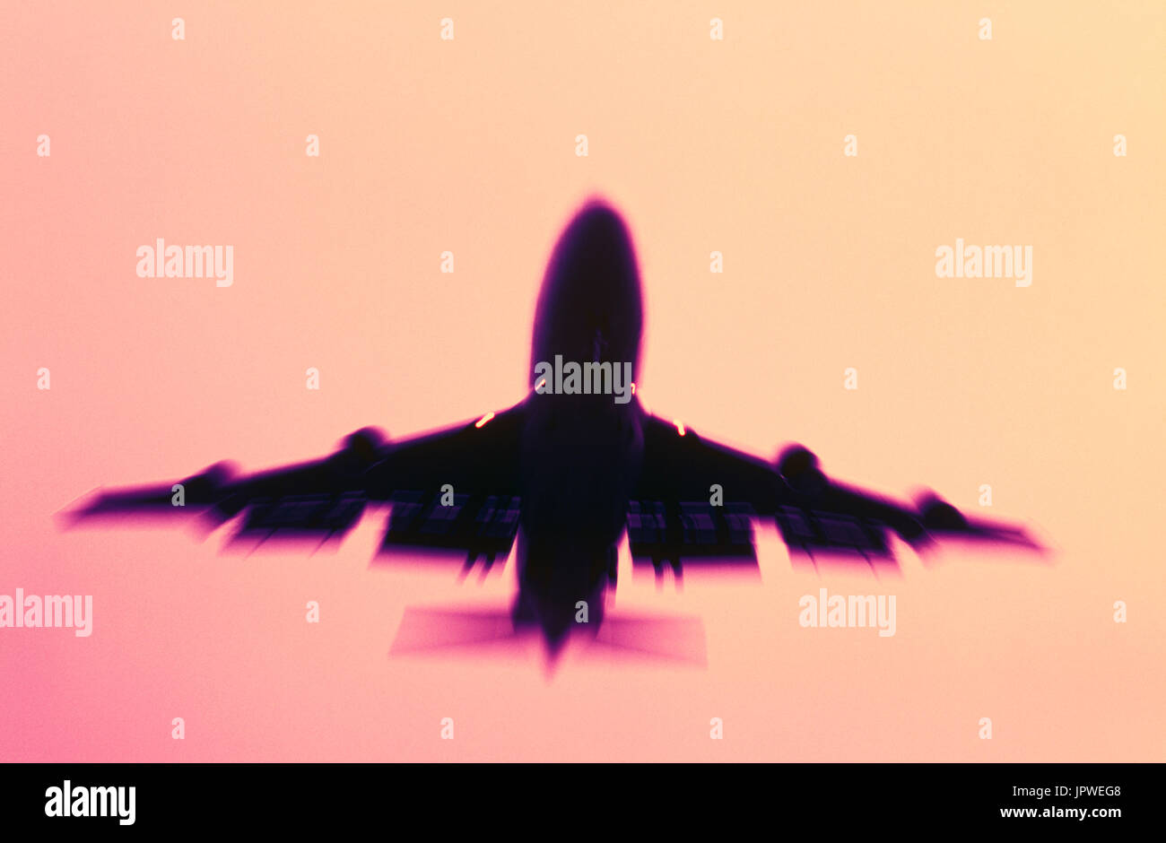 purple tint of a Boeing 747-400 climbing enroute Stock Photo - Alamy