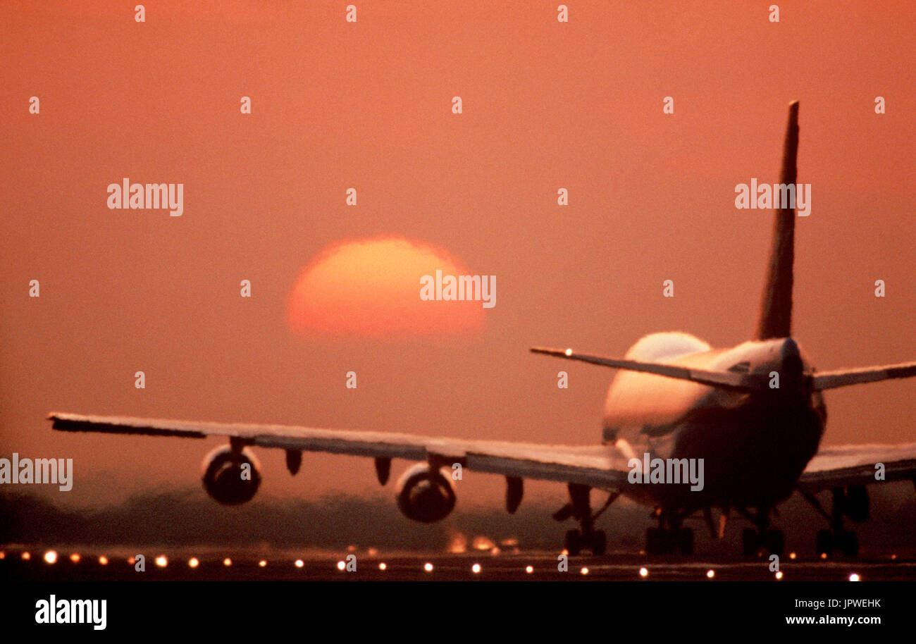 Boeing 747 taking-off at sunset with runway-lights on Stock Photo - Alamy