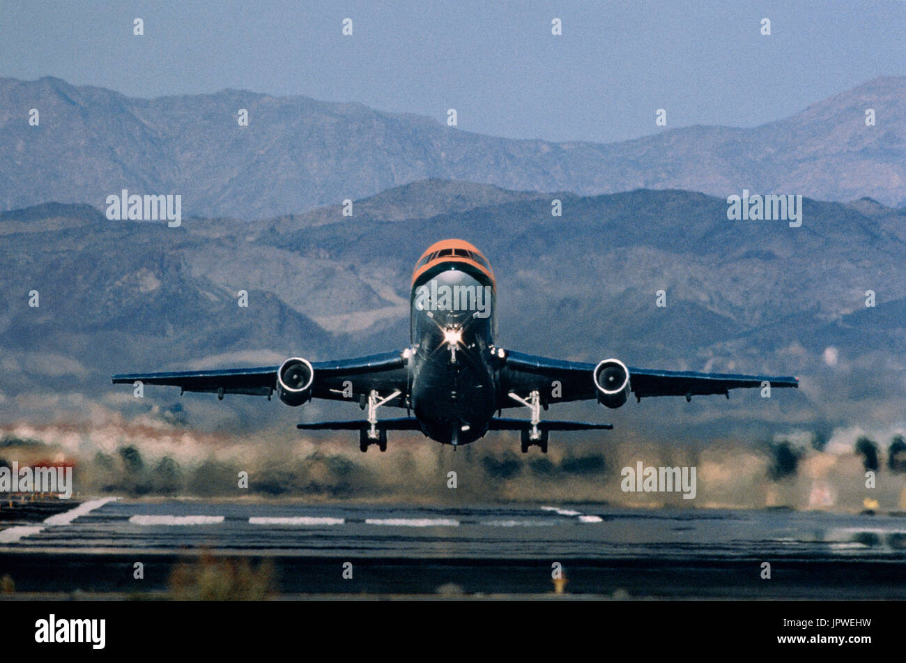 Lockheed L-1011 Tristar airliner taking-off with mountains behind Stock ...