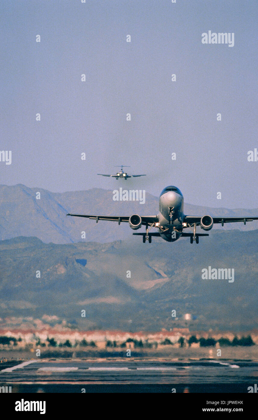 Airbus A320 taking-off with a Boeing 727 on final-approach landing ...
