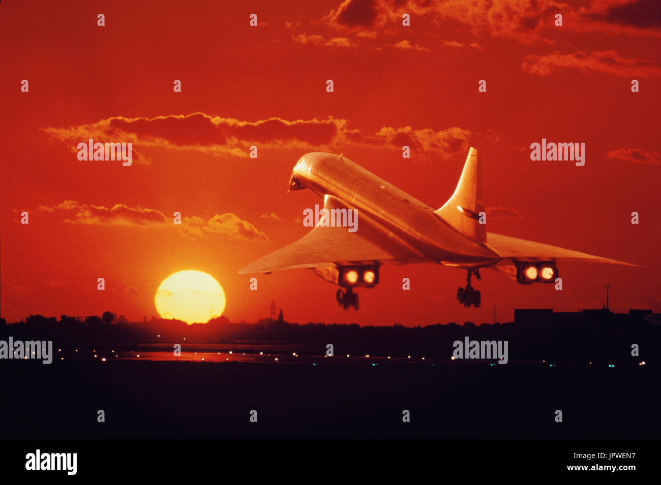 Aerospatiale BAC Concorde taking-off on the runway at sunset with ...