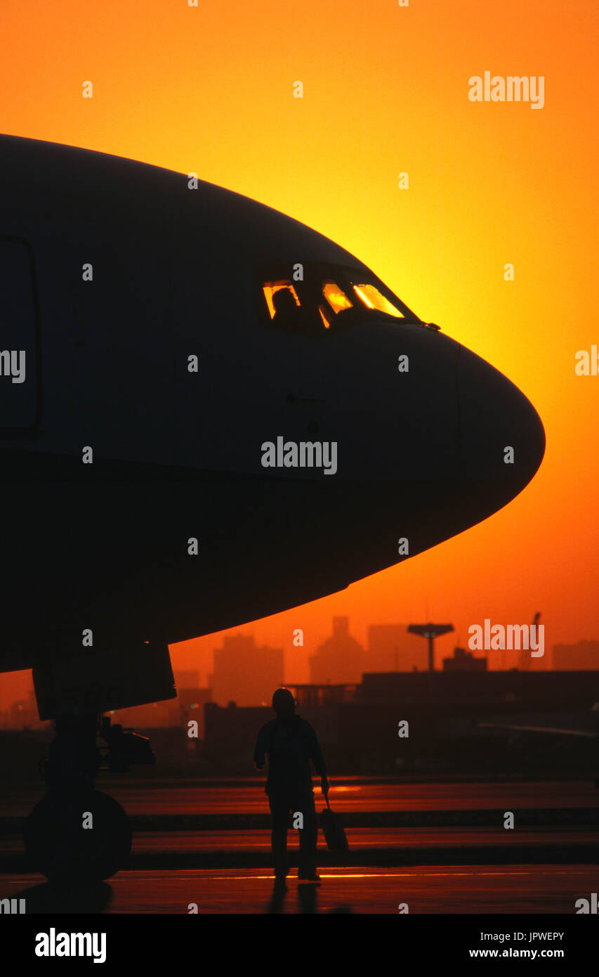 marshaller and nose of an ANA Boeing 767-300 with pilot in the cockpit ...