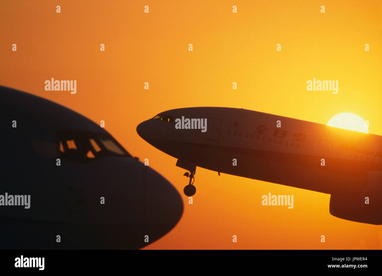 ANA Boeing 767-200 taking-off with nose of 767 and sunset behind Stock ...