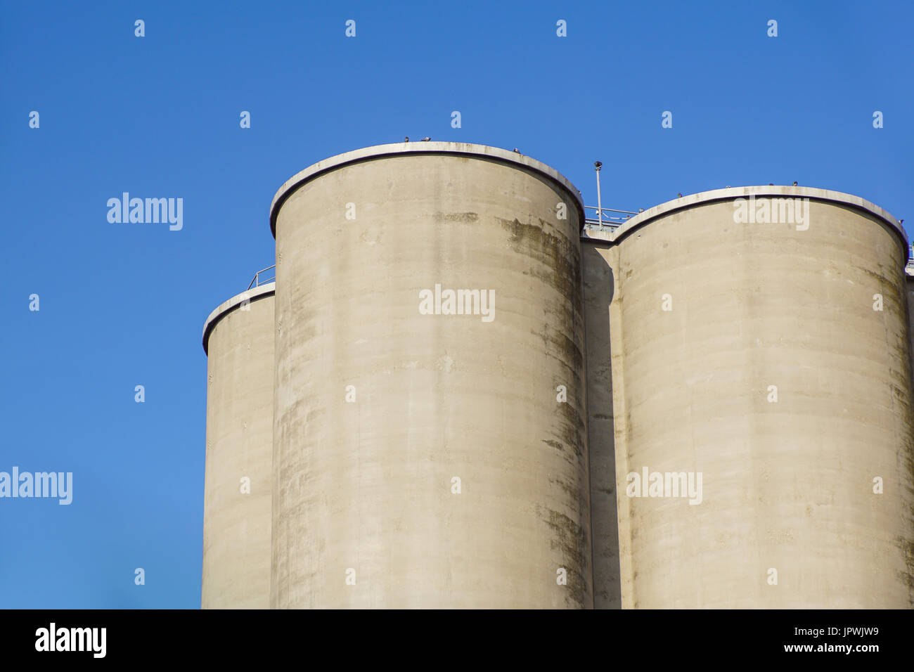 Exterior view of a cement factory, Silos for storage Stock Photo - Alamy