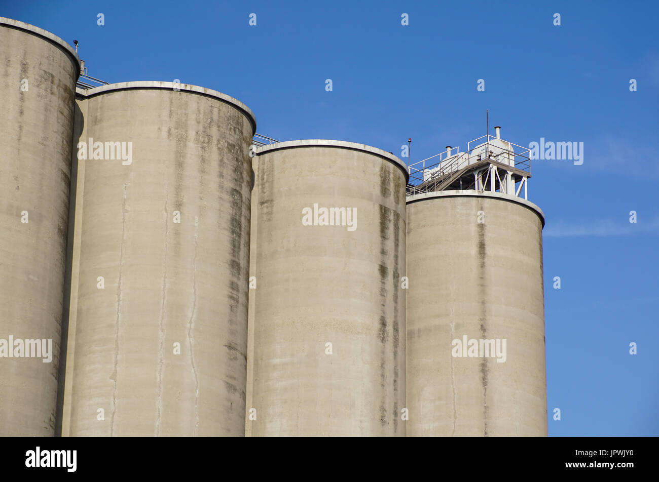 Exterior view of a cement factory, Silos for storage Stock Photo - Alamy