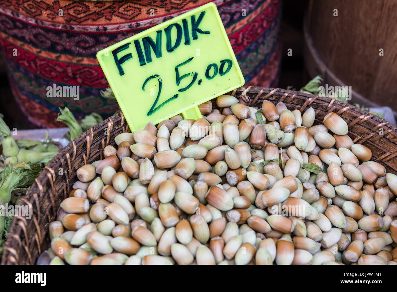 Green hazelnuts in shells for sale.”Hazelnuts 25 Turkish Lira” written ...