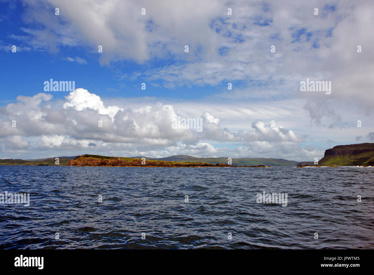 Approaching Inch Kenneth from the sea with the cliffs of the Isle of ...