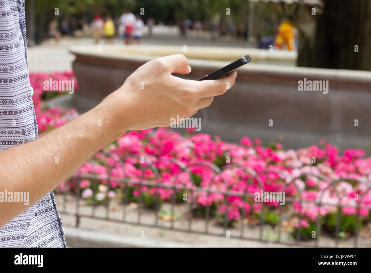 Hand of an anonymous man talking phone in park Stock Photo - Alamy
