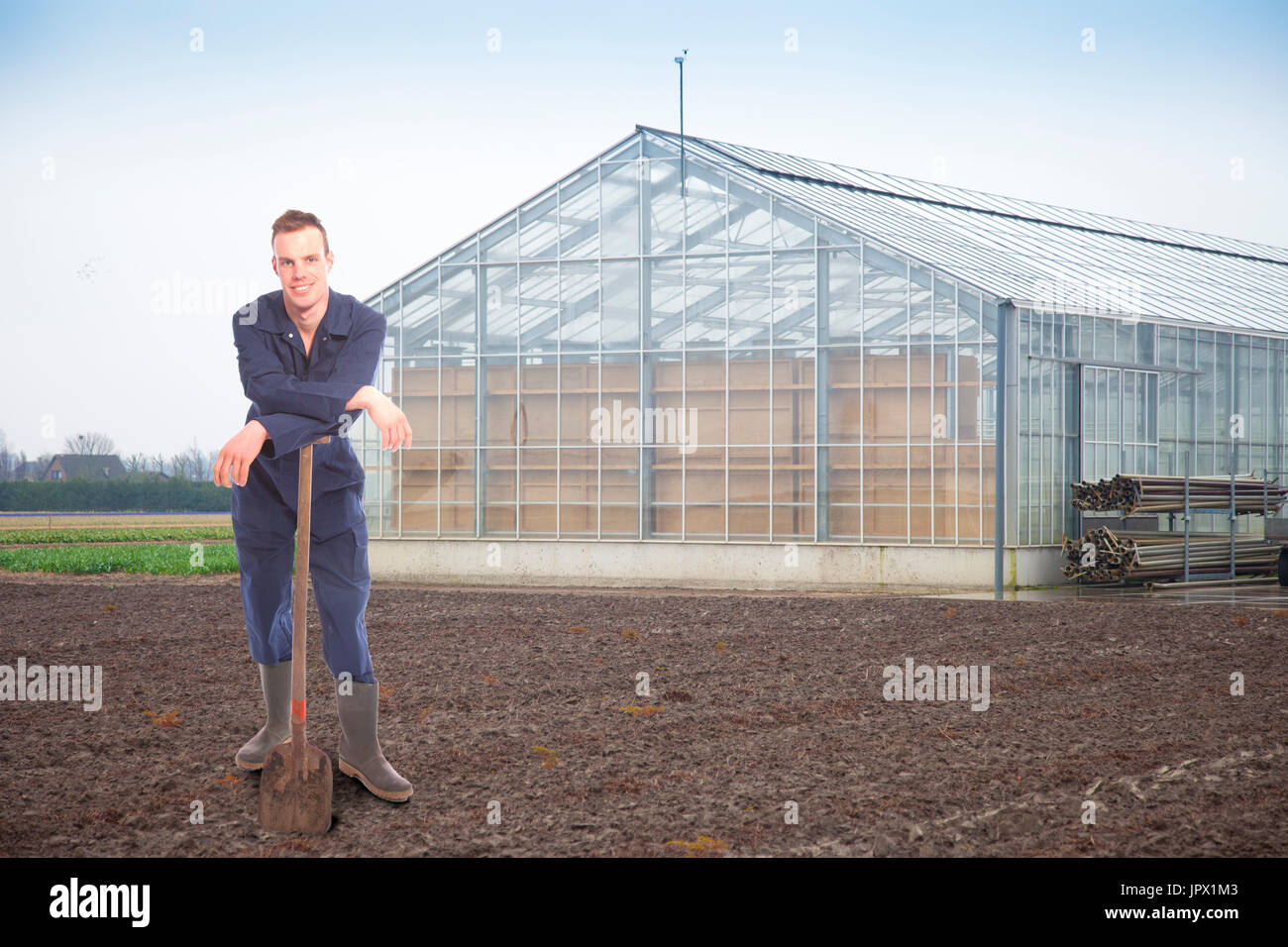 Young farmer outside a glass house Stock Photo - Alamy