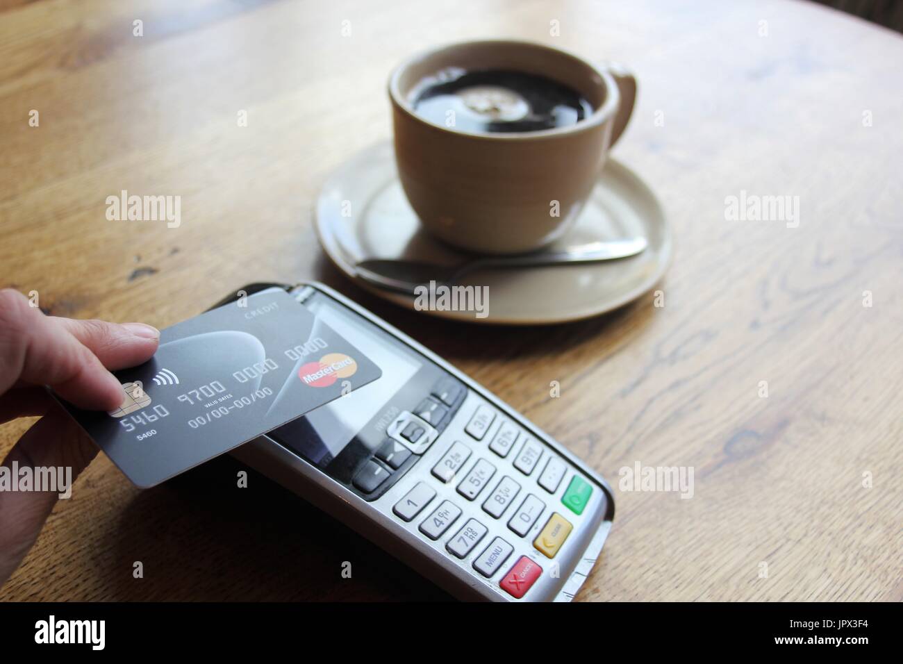 contactless payment card pdq background copy space with hand holding ...