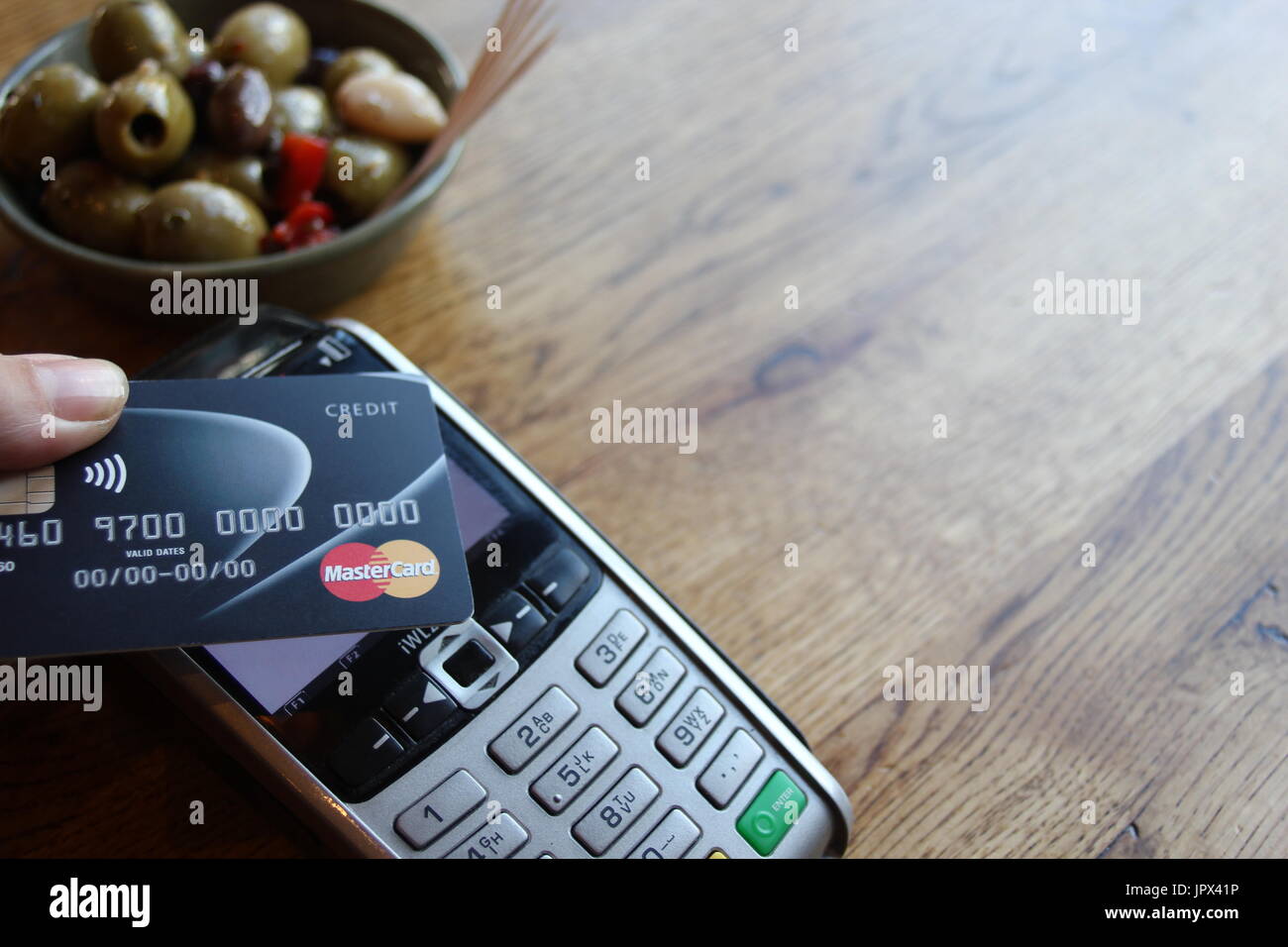 contactless payment card pdq background copy space with hand holding ...