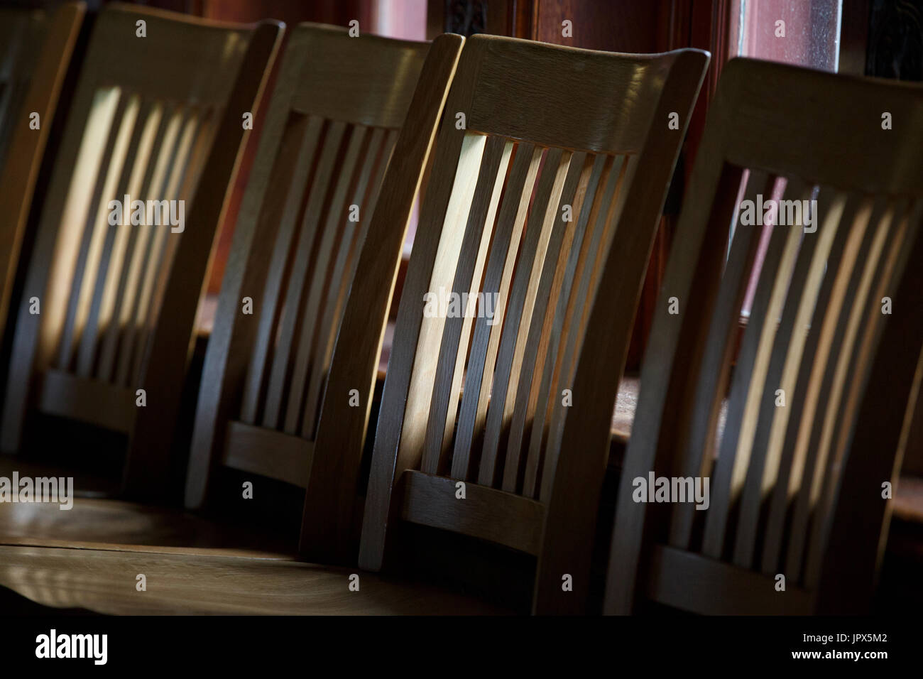 Light shining through wooden chair packs Stock Photo - Alamy