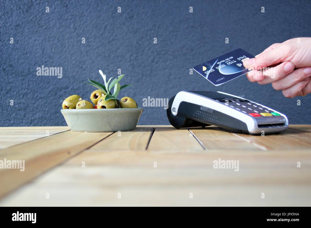 contactless payment card pdq background copy space with hand holding ...