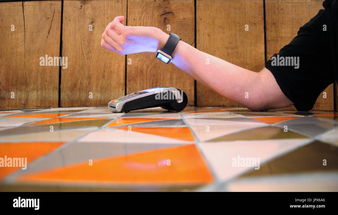 contactless payment smart watch pdq with hand holding credit card ready ...