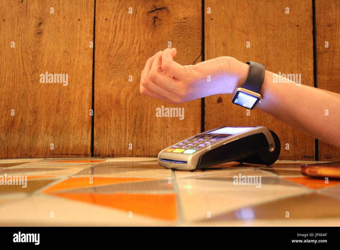 contactless payment smart watch pdq with hand holding credit card ready ...