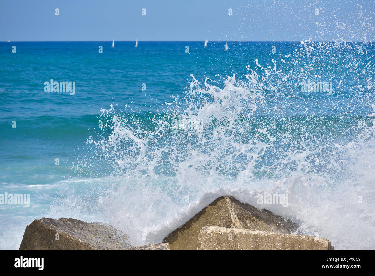 Splash water of sea wave attack to the rock phot with outdoor sunny ...